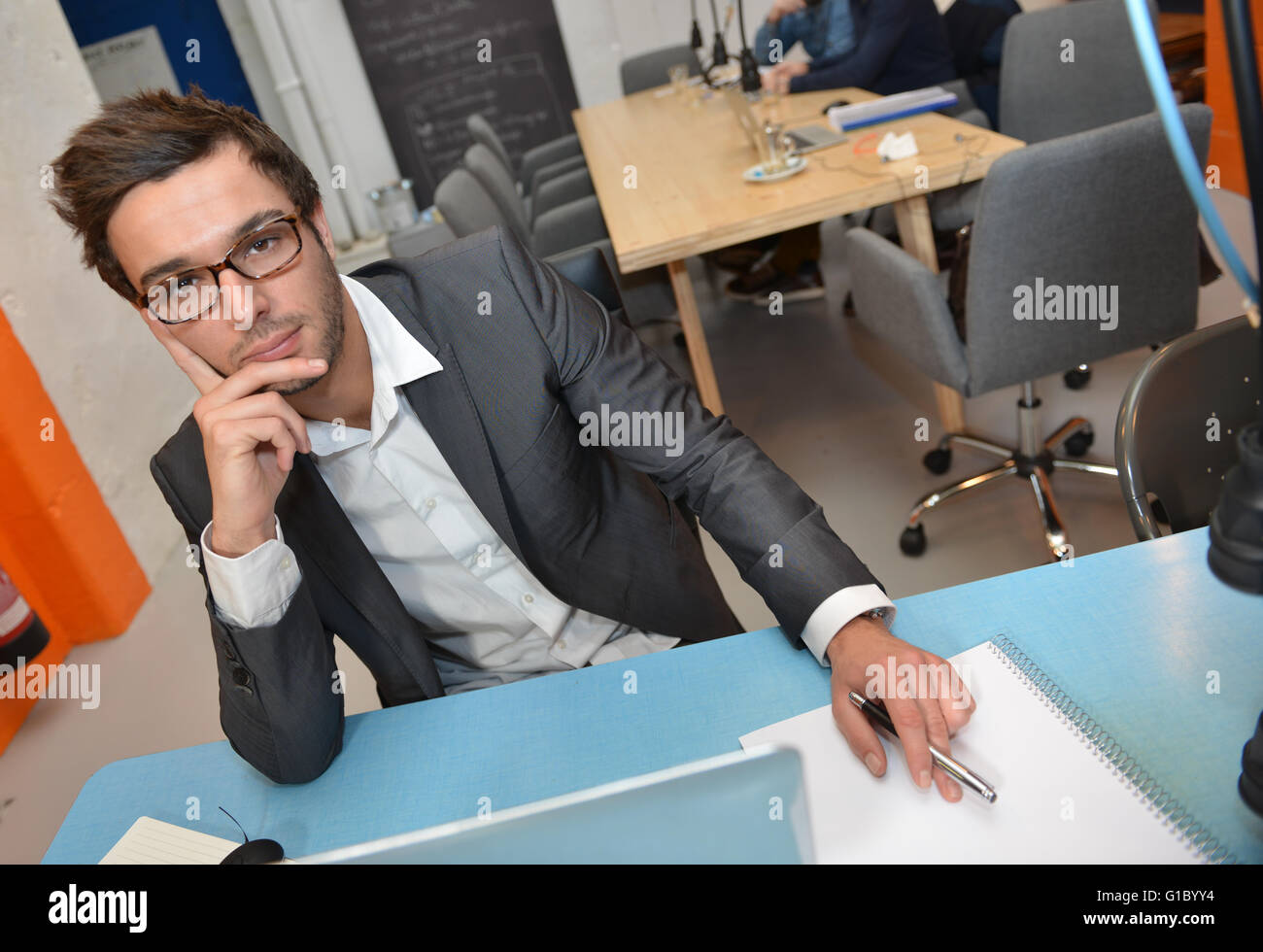 Portrait of smiling Businessman posing in coworking office Stock Photo ...