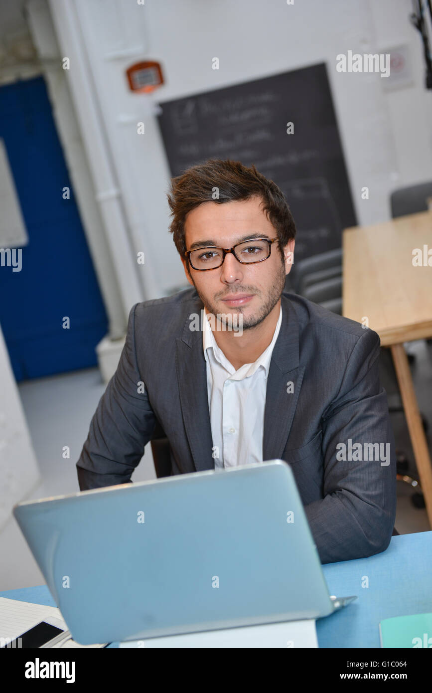Portrait of smiling Businessman posing in coworking office Stock Photo ...