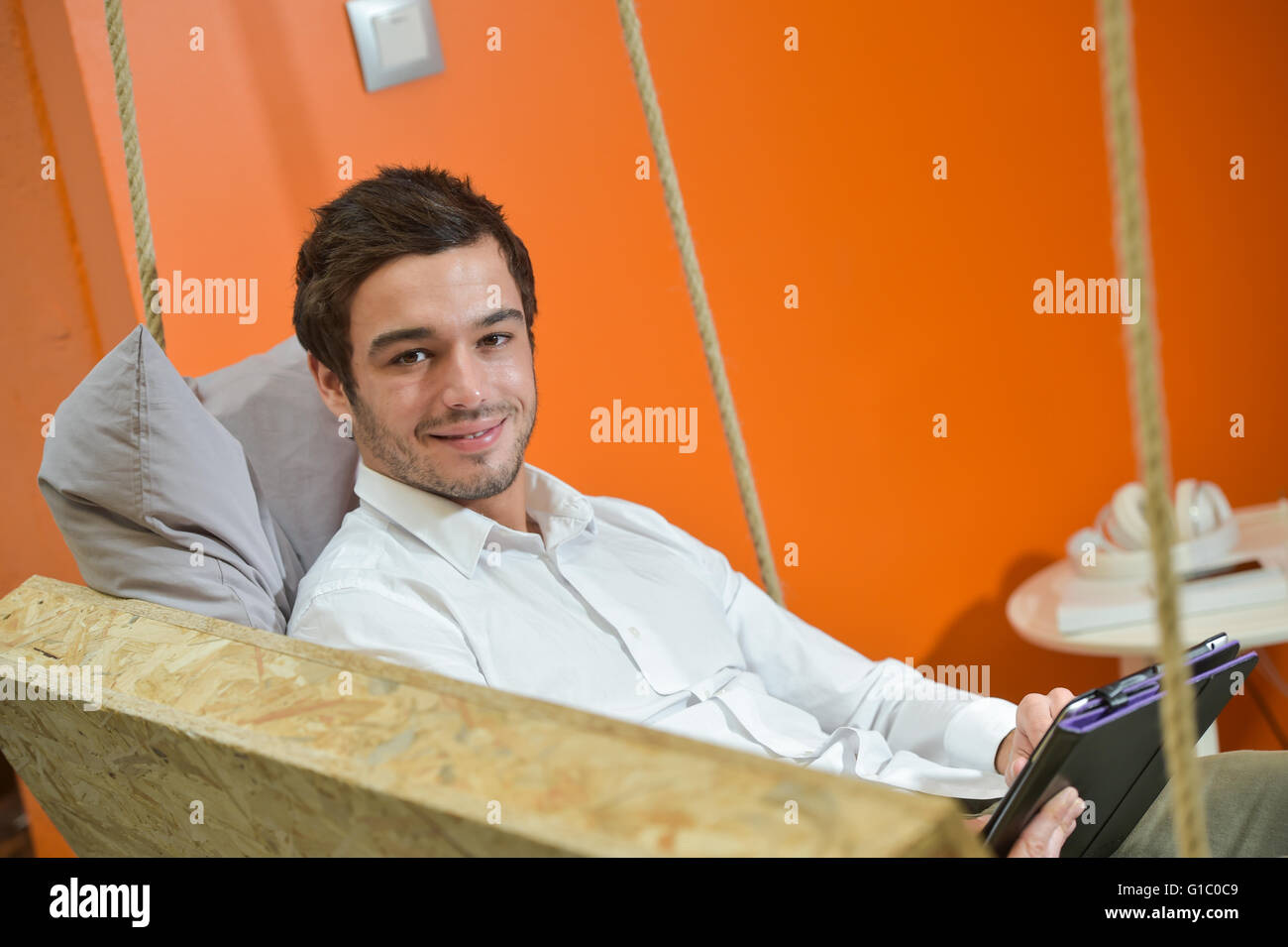 Man in office relaxing with tablet Stock Photo - Alamy