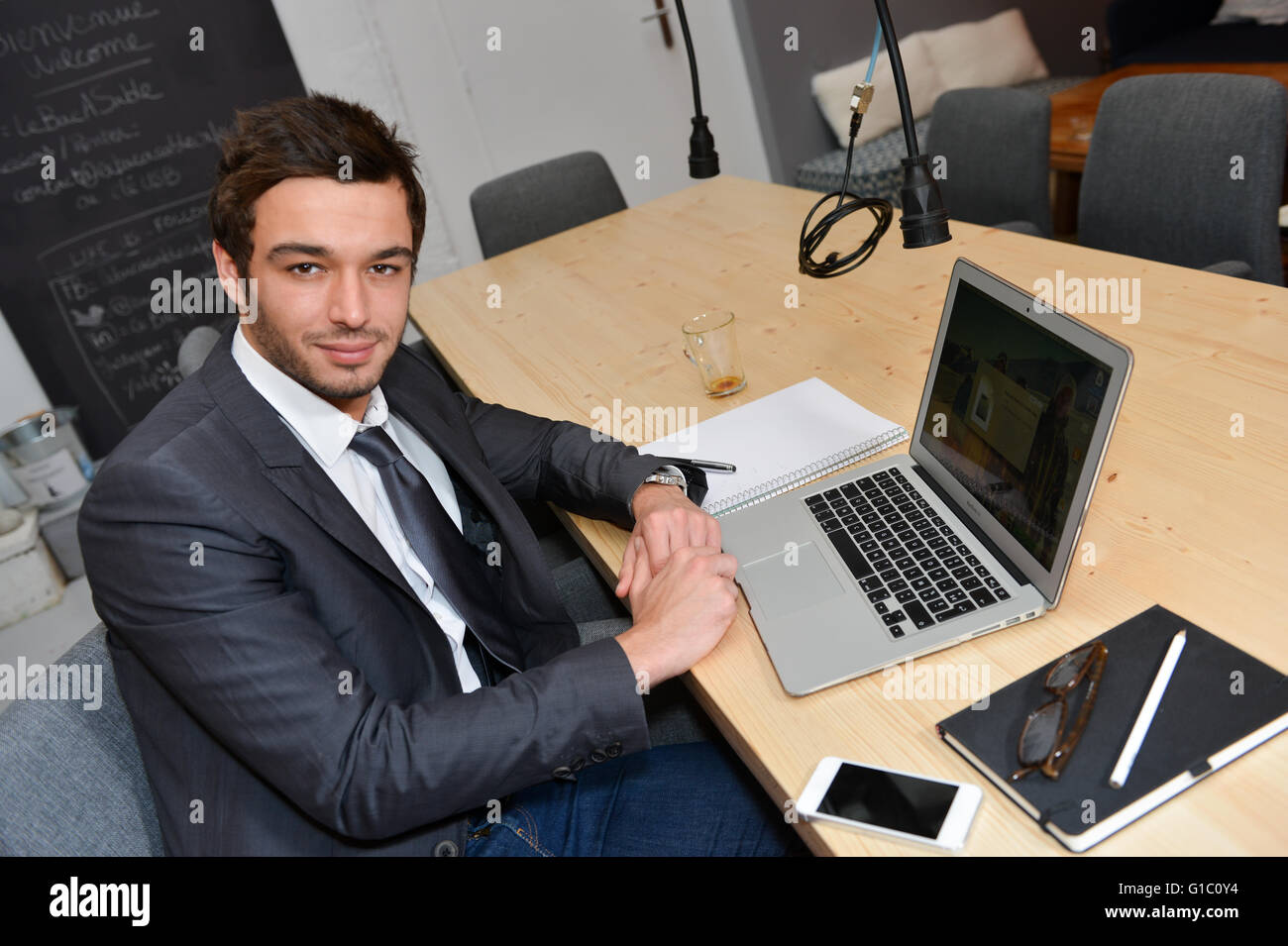 Portrait of smiling Businessman posing in coworking office Stock Photo ...