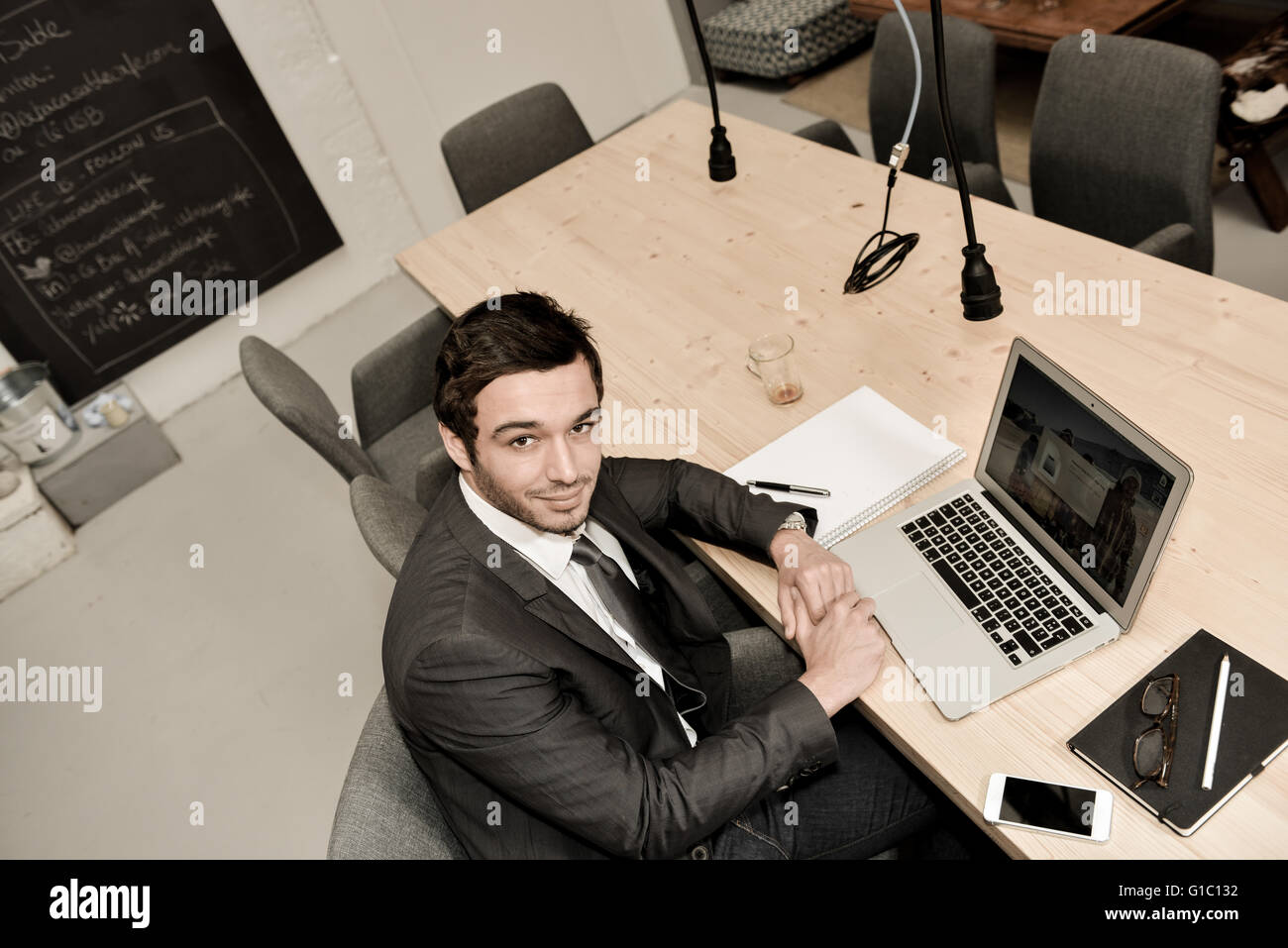 Portrait of smiling Businessman posing in coworking office Stock Photo ...