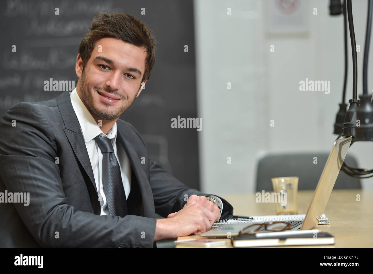 Portrait of smiling Businessman posing in coworking office Stock Photo ...