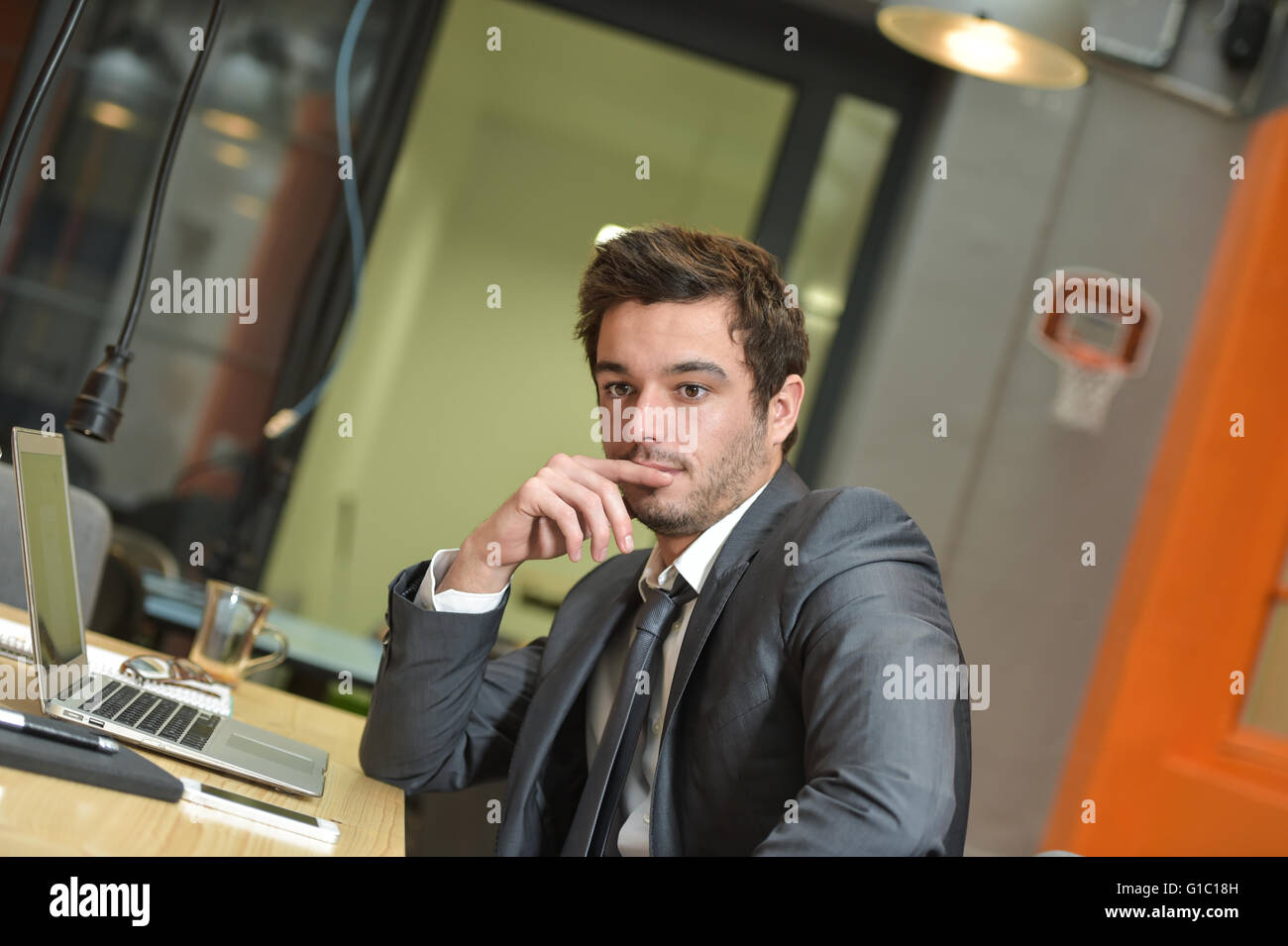 Portrait of smiling Businessman posing in coworking office Stock Photo ...
