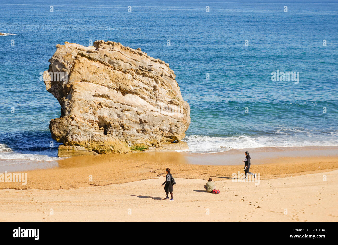 People around huge rock formation at Grande Plage, beach. Atlantic ...