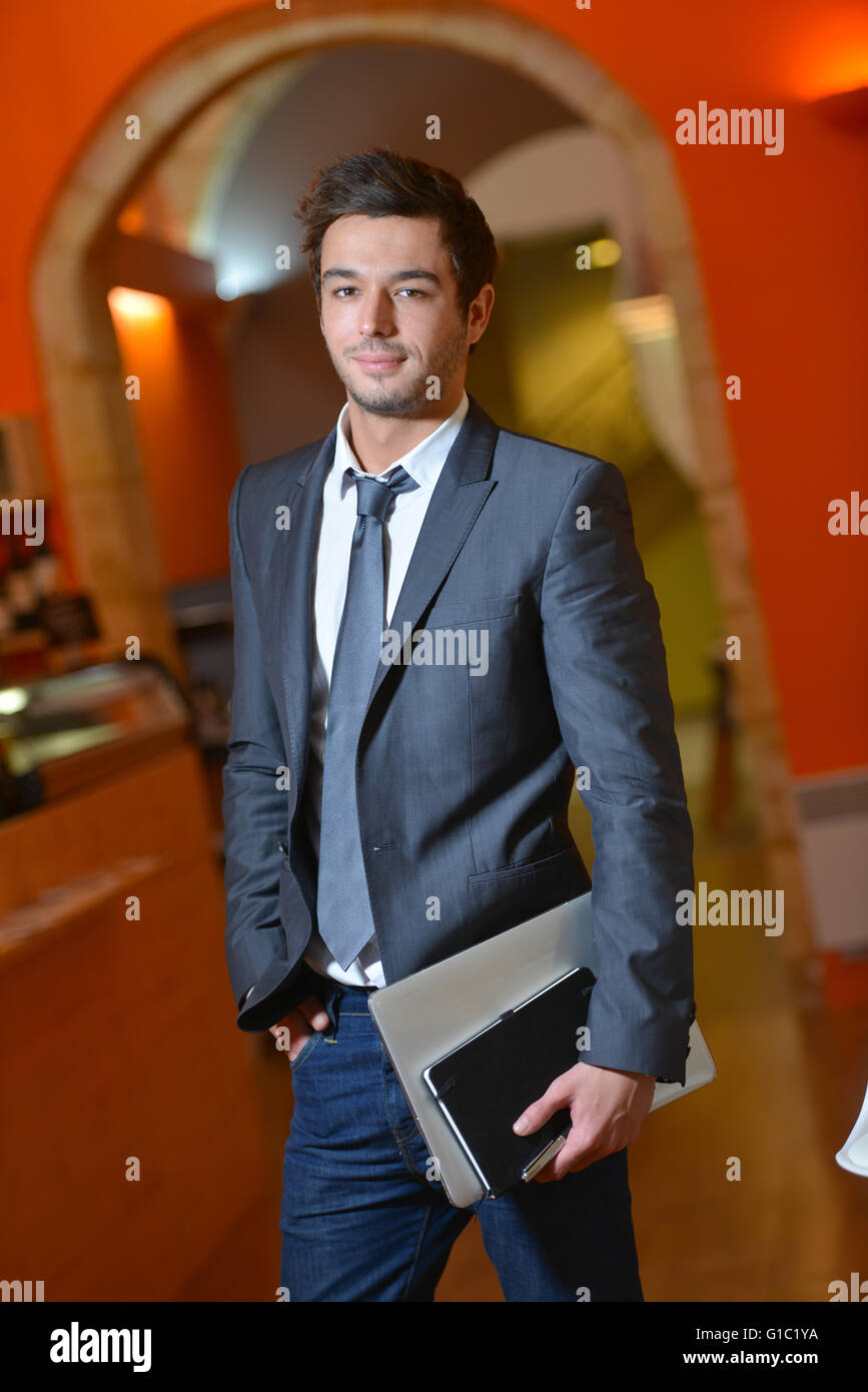 Portrait of smiling Businessman posing in coworking office Stock Photo ...