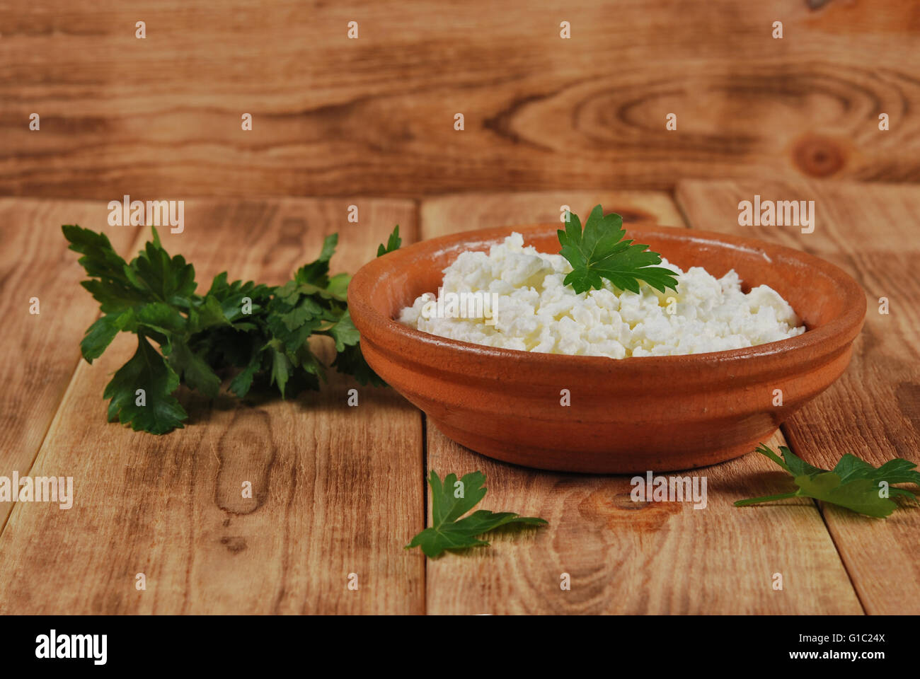 cottage cheese in a small brown bowl on a wooden background Stock Photo ...
