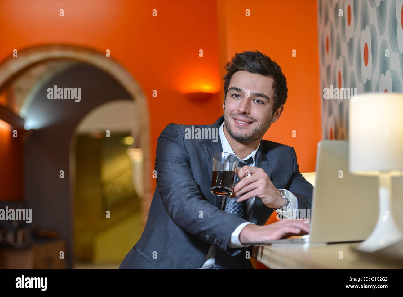 Handsome business man in restaurant drinking coffee Stock Photo - Alamy
