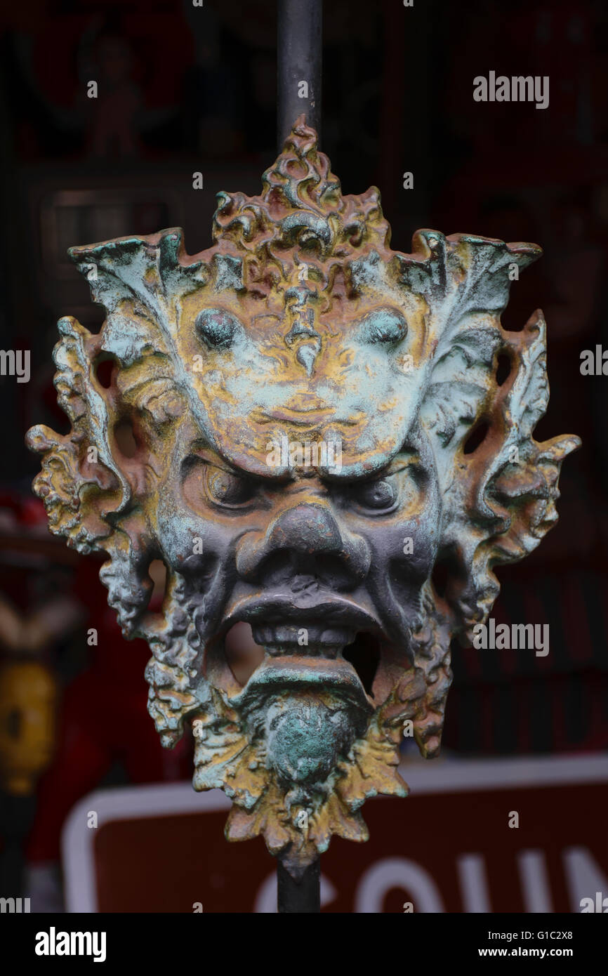Scary Iron face on a gate Stock Photo - Alamy