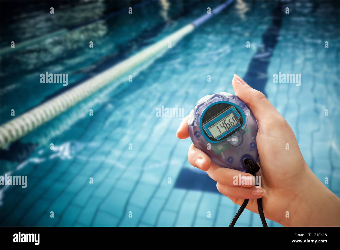 Composite image of close up of a hand holding a timer on a white ...