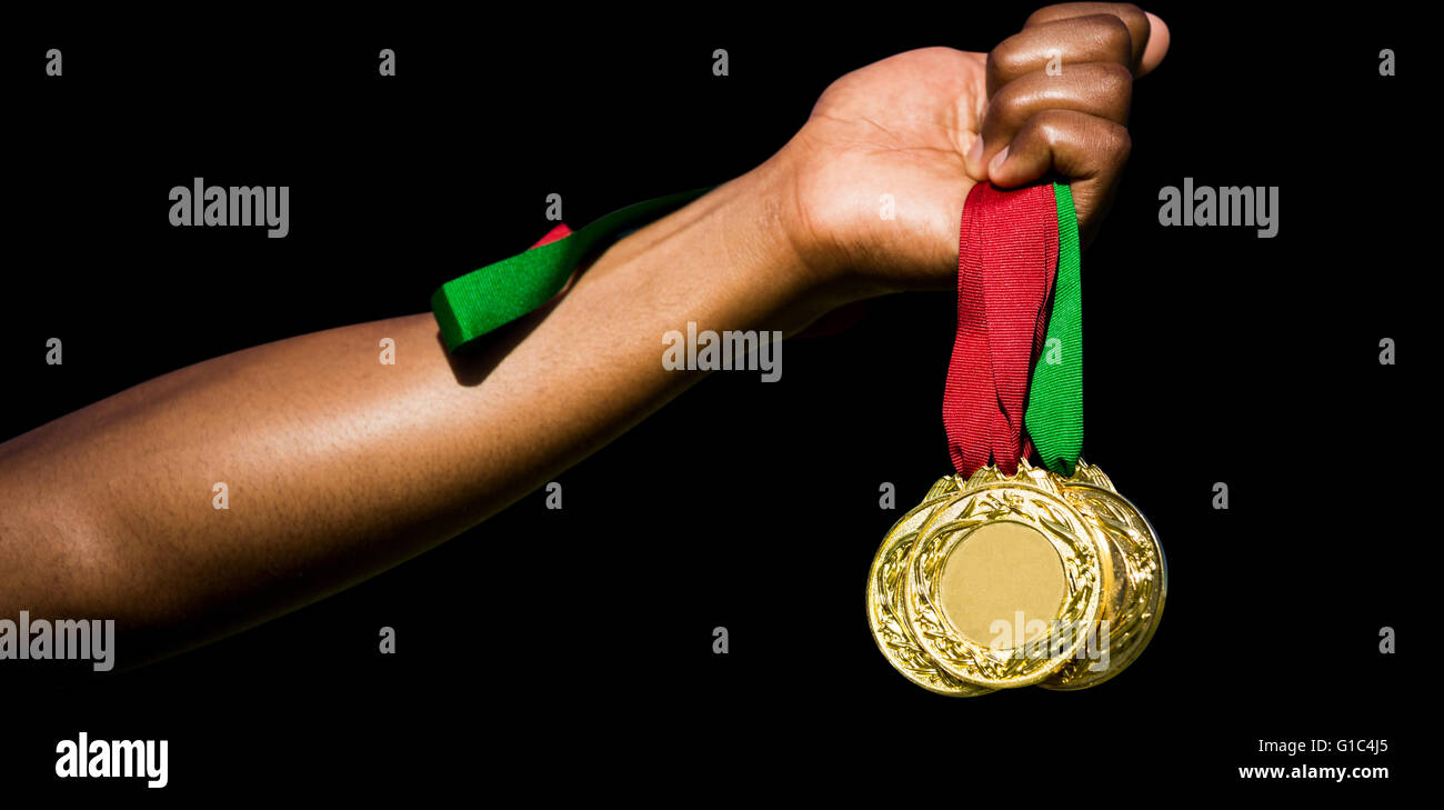 Hand holding three gold medals on white background Stock Photo - Alamy