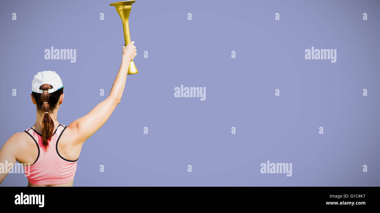 Composite image of rear view of sportswoman raising a cup Stock Photo ...