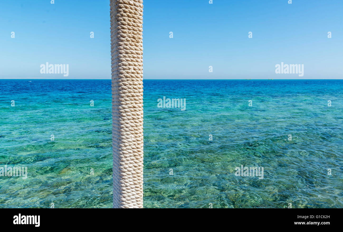 wooden pole with rope entwined Stock Photo - Alamy