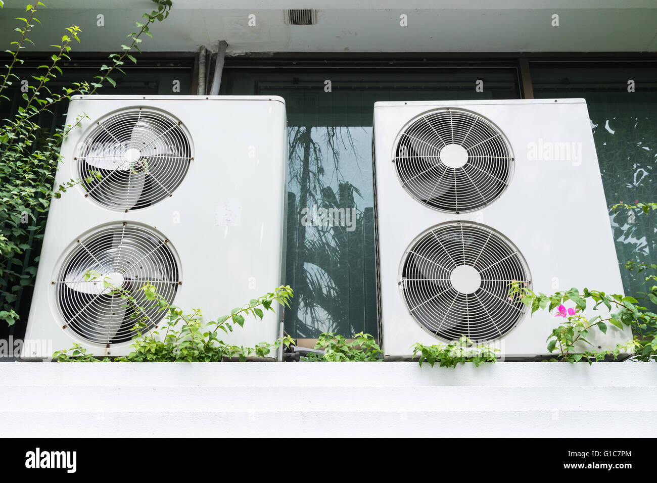 Double twin fan air compressor unit outside the office building Stock ...