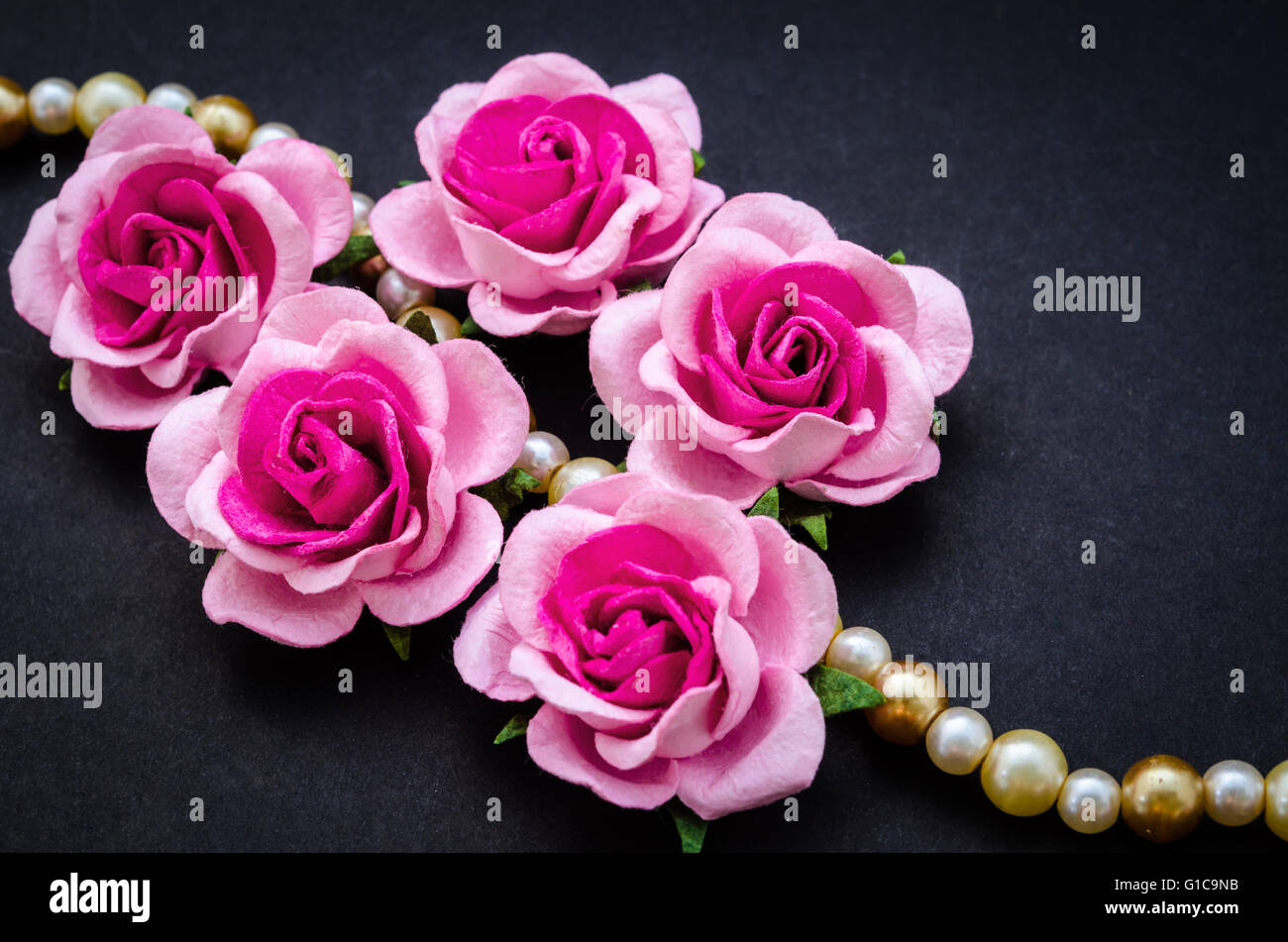 Pink roses with pearl necklace on black background. Love concept Stock ...