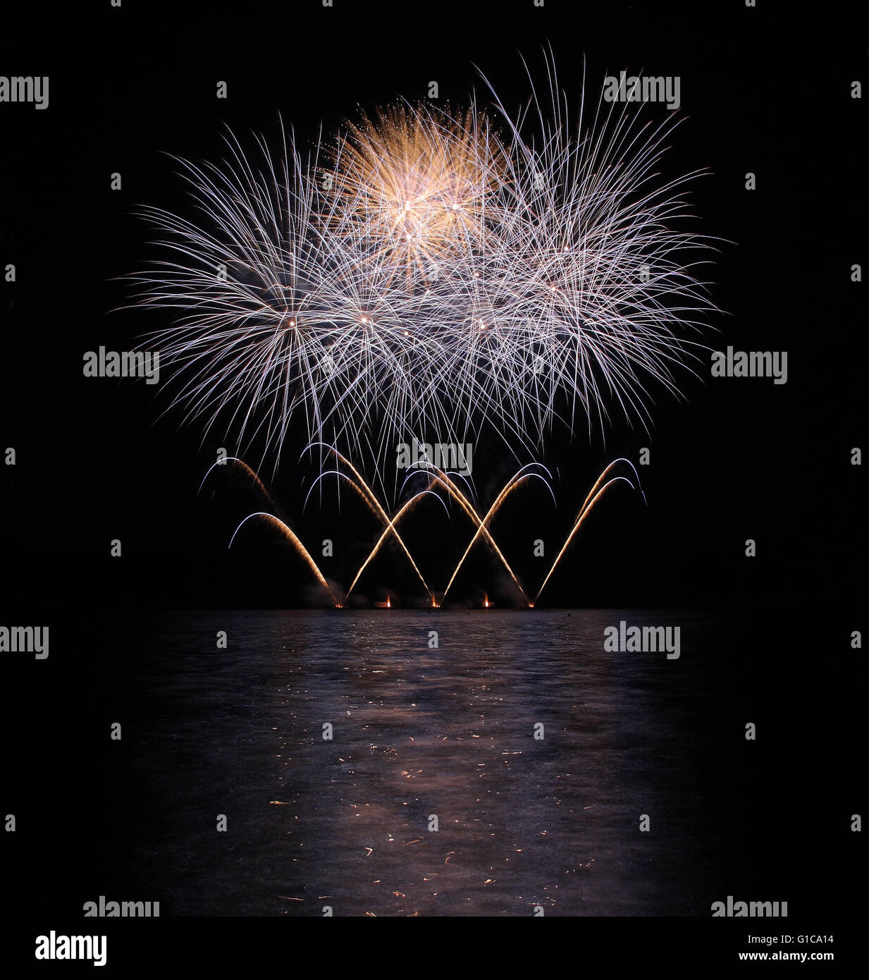 Colorful fireworks with reflection on lake and night sky in background ...