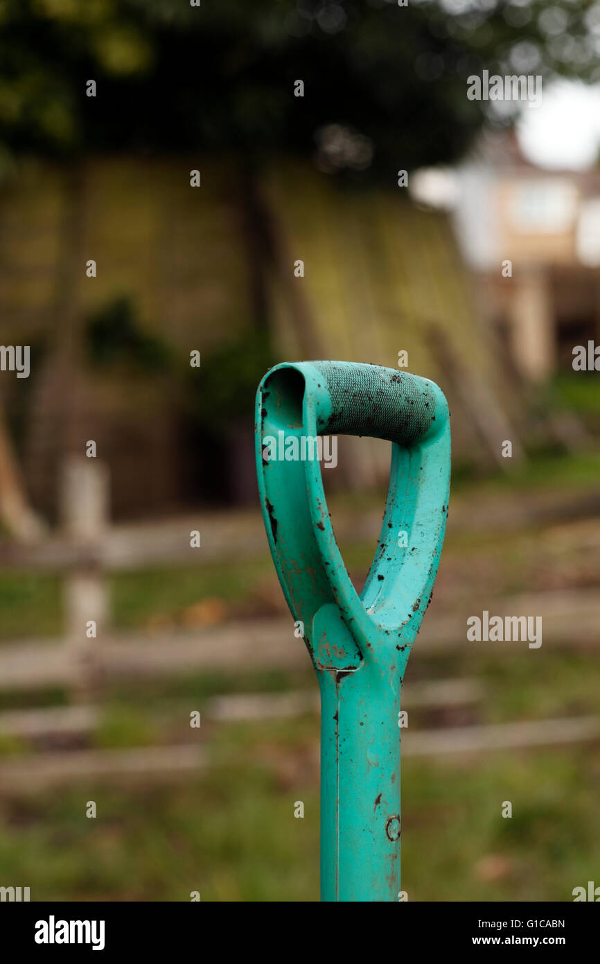 spade or fork handle on an allotment, made of green plastic Stock Photo ...