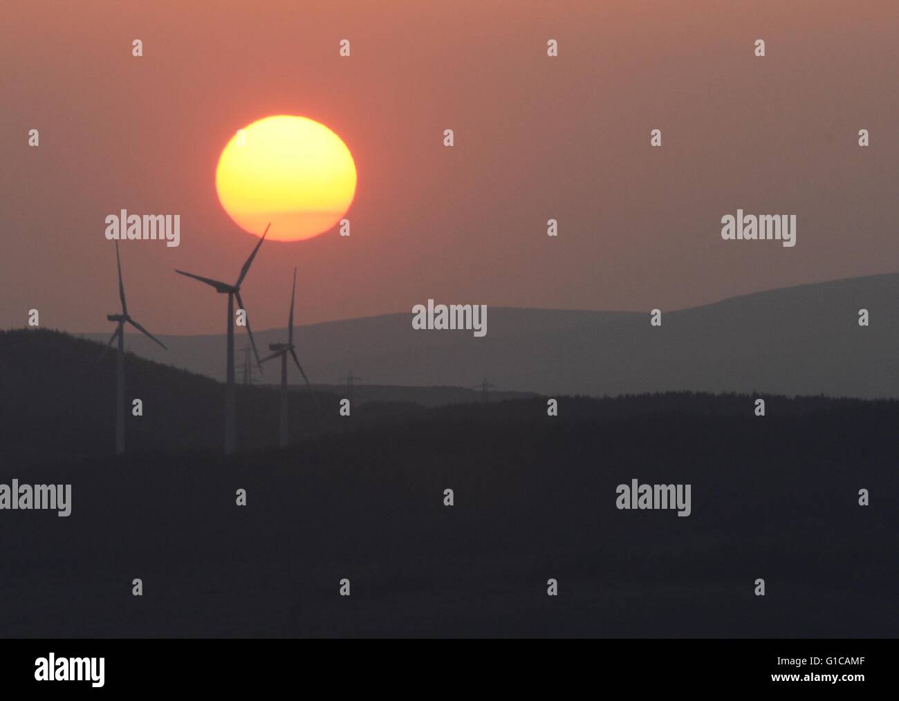 The sun sets over wind turbines in the Neath Valley, Wales UK Stock ...