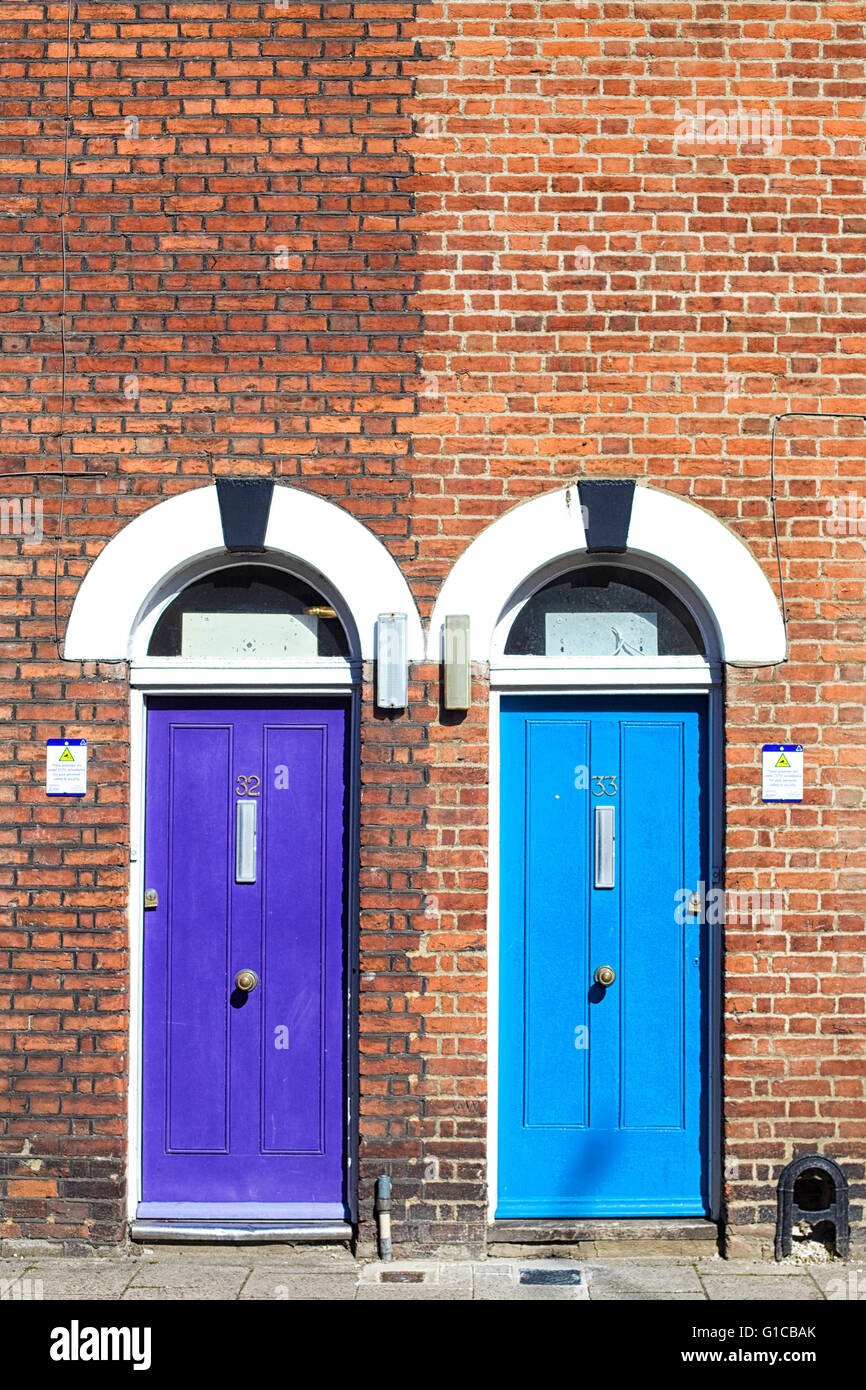 Blue and purple wooden doors with different colored brickwork houses ...