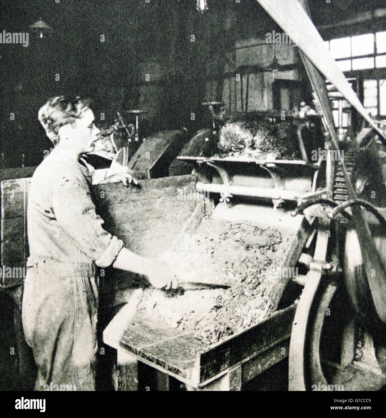 workman sorts ground graphite on a grinding machine at a pencil factory ...