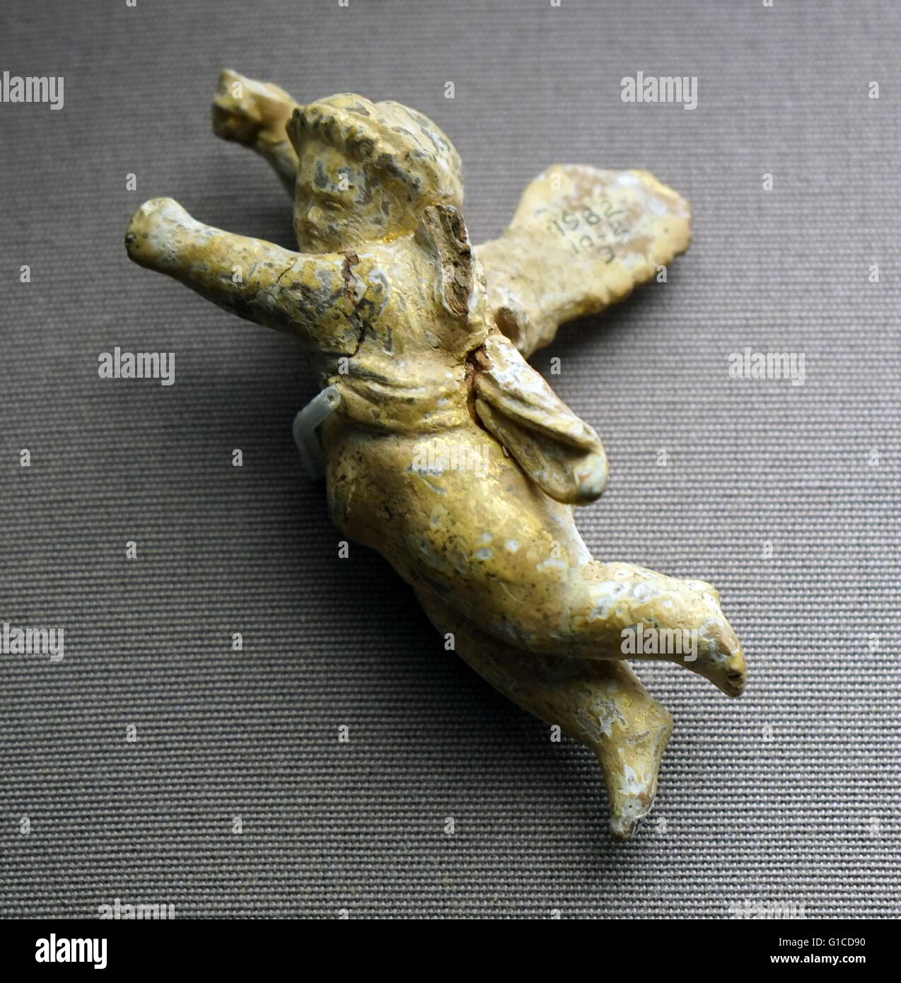 Painted and gilded terracotta figure of Eros, the Greek god of love, in ...