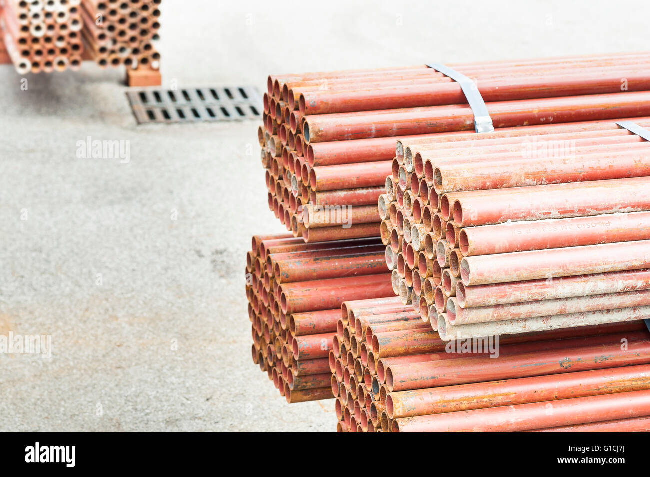 Stack of steel pipes for scaffolding in warehouse Stock Photo - Alamy