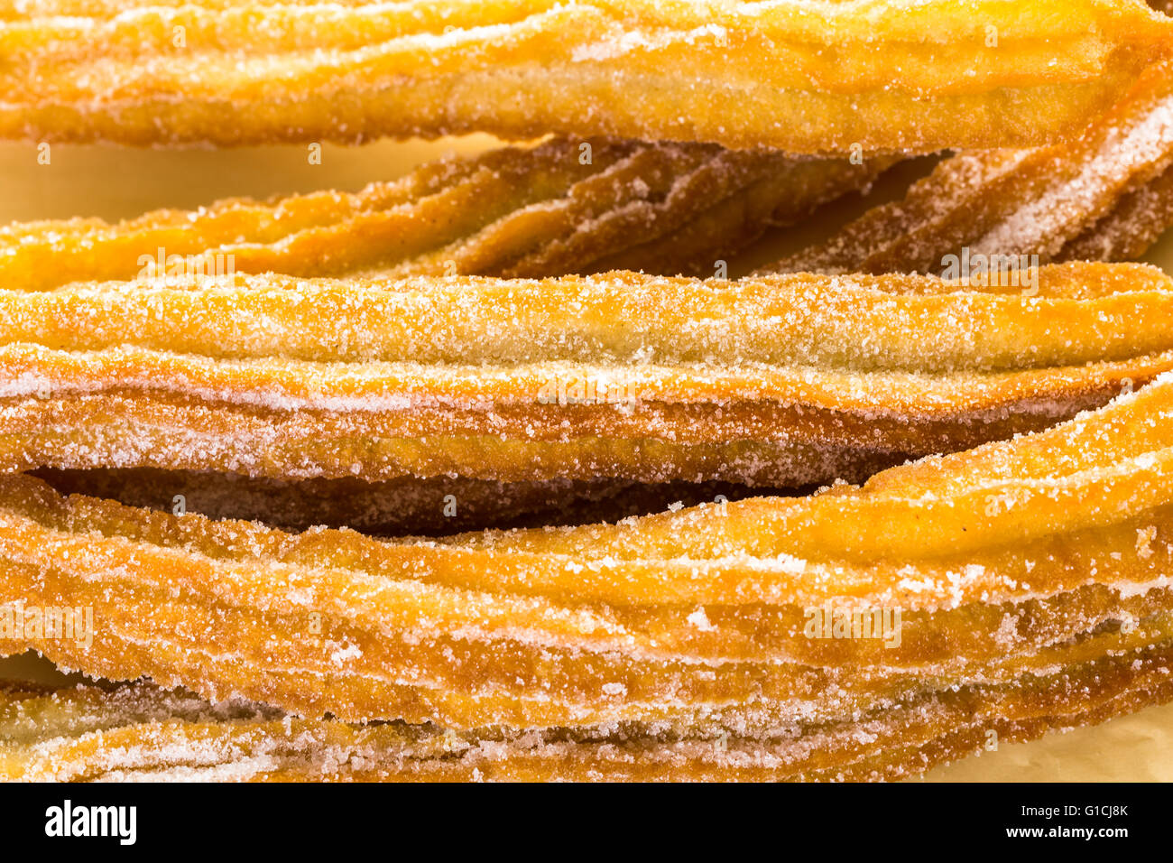 Bunch of curros covered with granulated sugar Stock Photo - Alamy