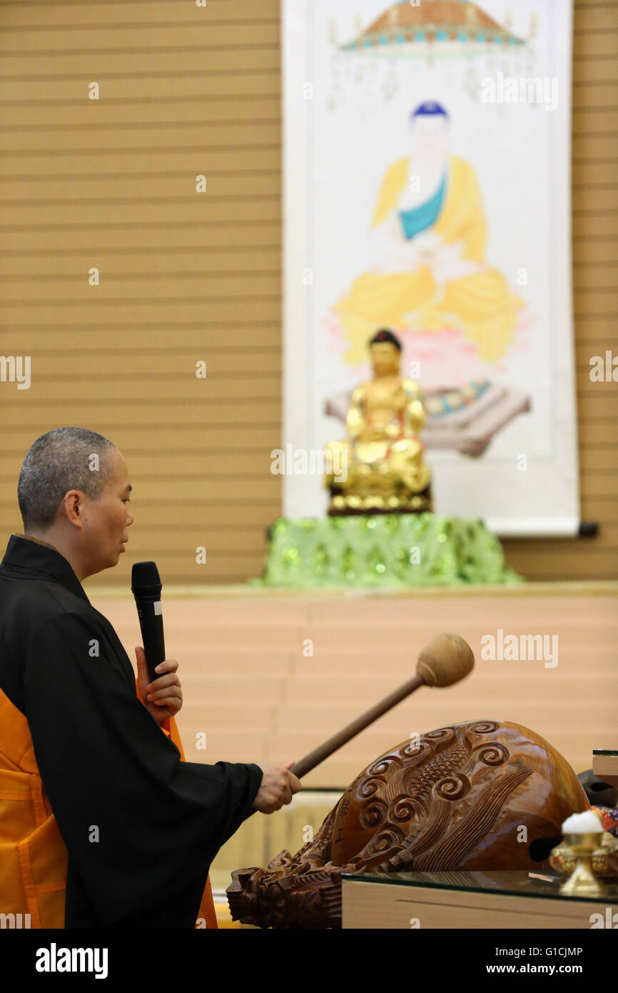 Fo Guang Shan temple. Monk playing on a wooden fish (percussion ...