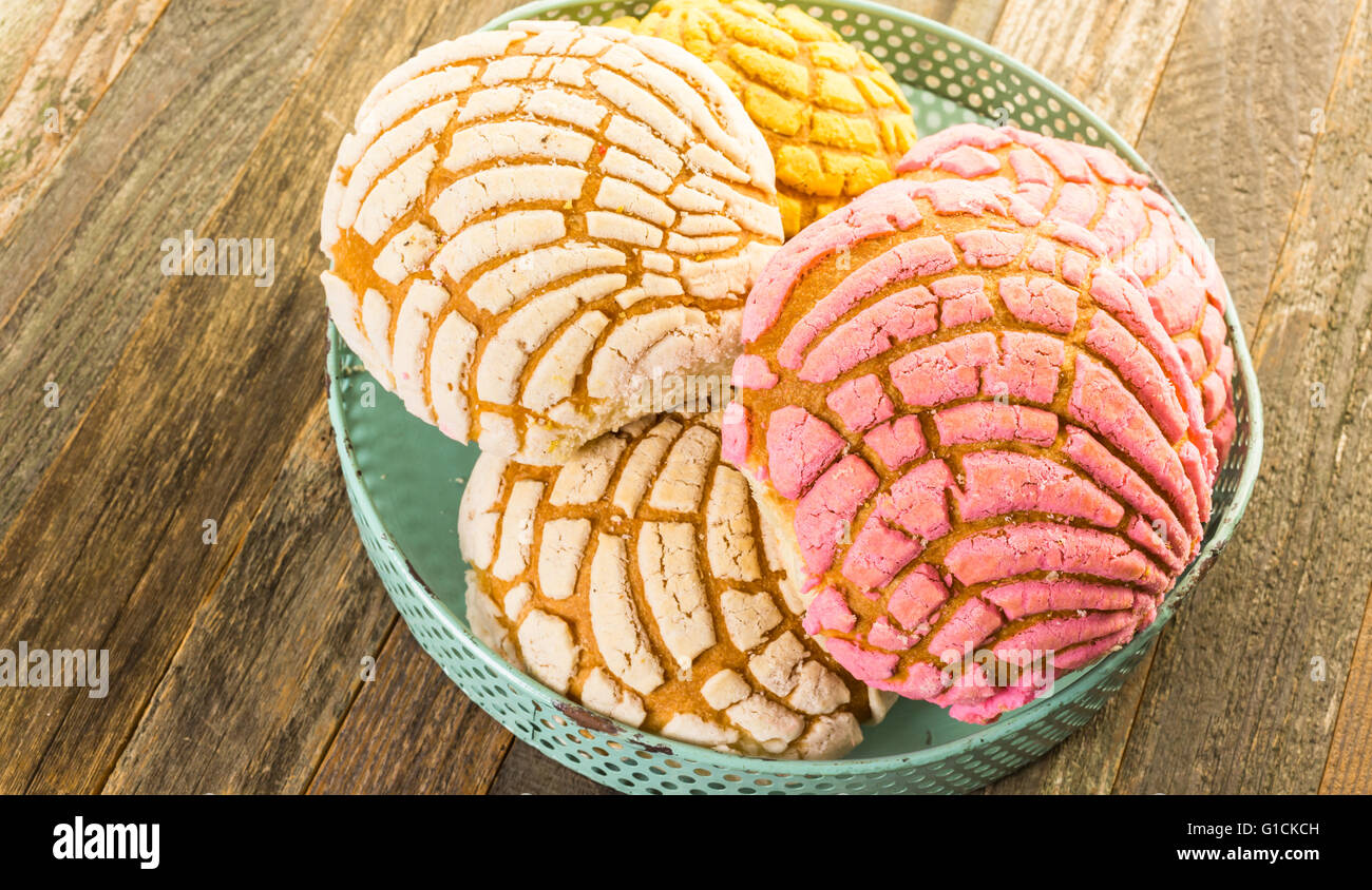 Homemade pan dulche with white, yellow, and pink icing Stock Photo - Alamy
