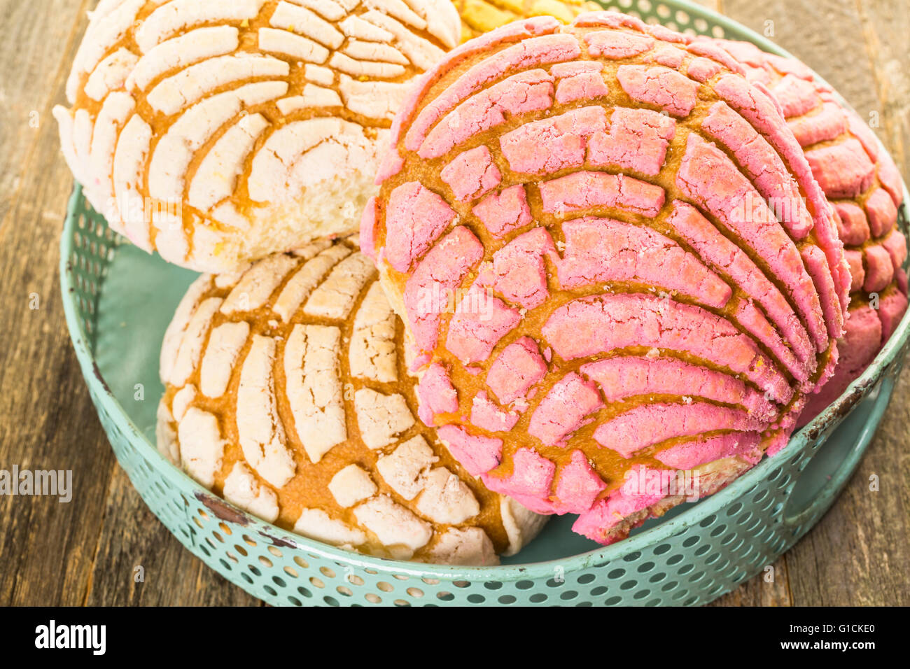 Homemade pan dulche with white, yellow, and pink icing Stock Photo - Alamy