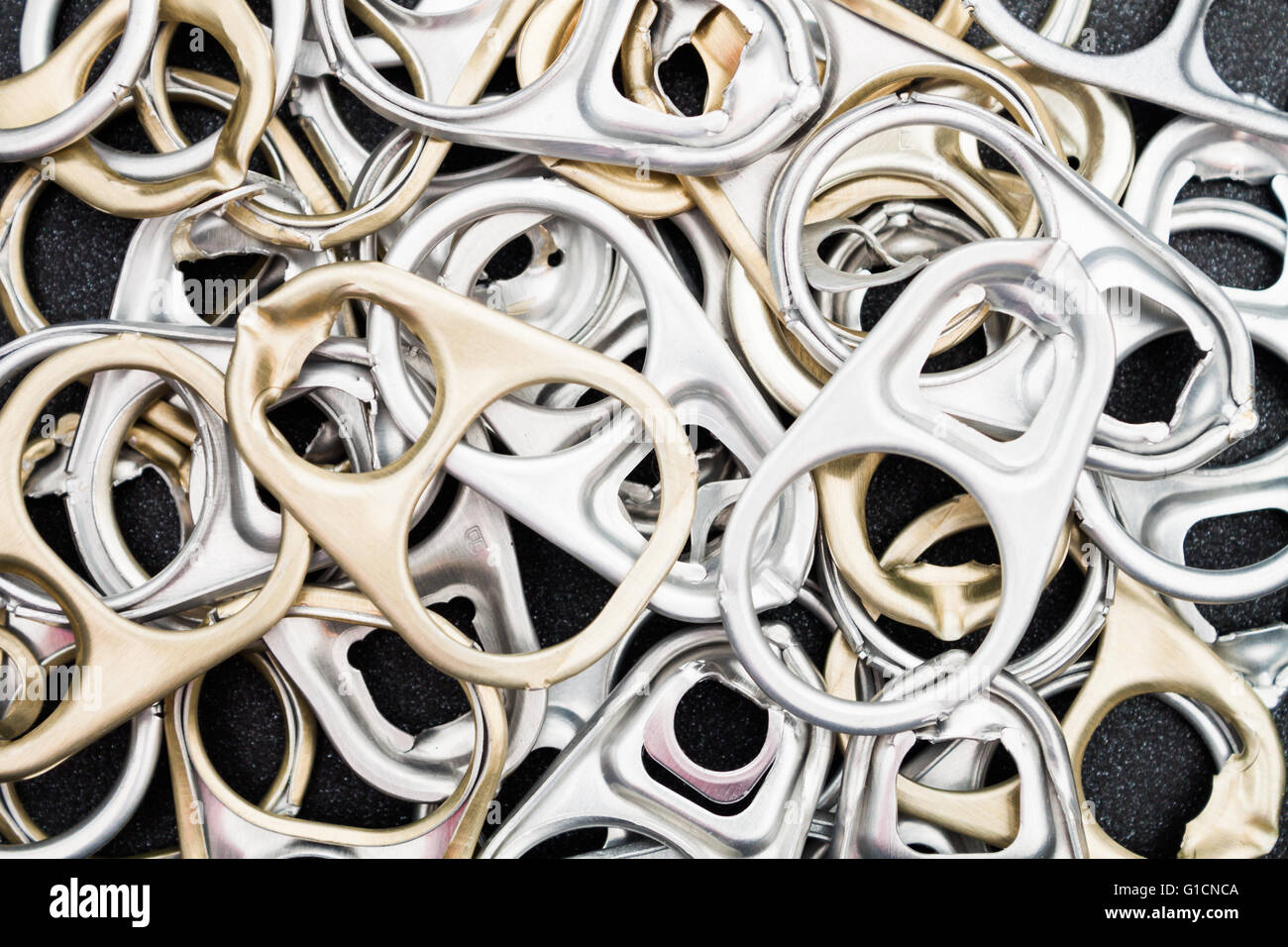 Ring pull cans opener on black metallic background Stock Photo - Alamy