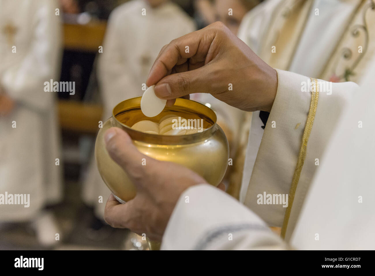 The christian rite of the Communion during the mass Stock Photo - Alamy