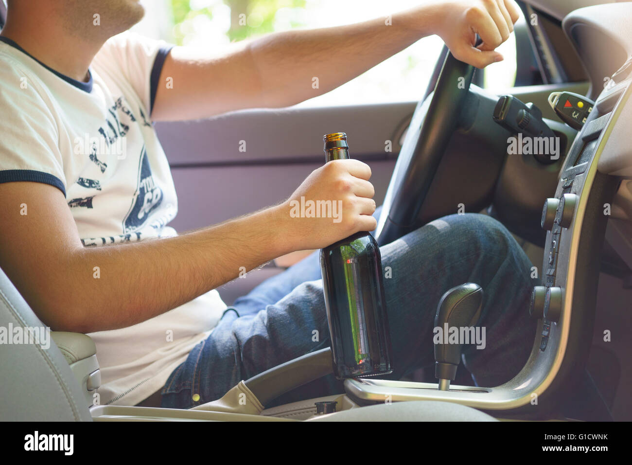 Man drinking beer while driving the car Stock Photo - Alamy