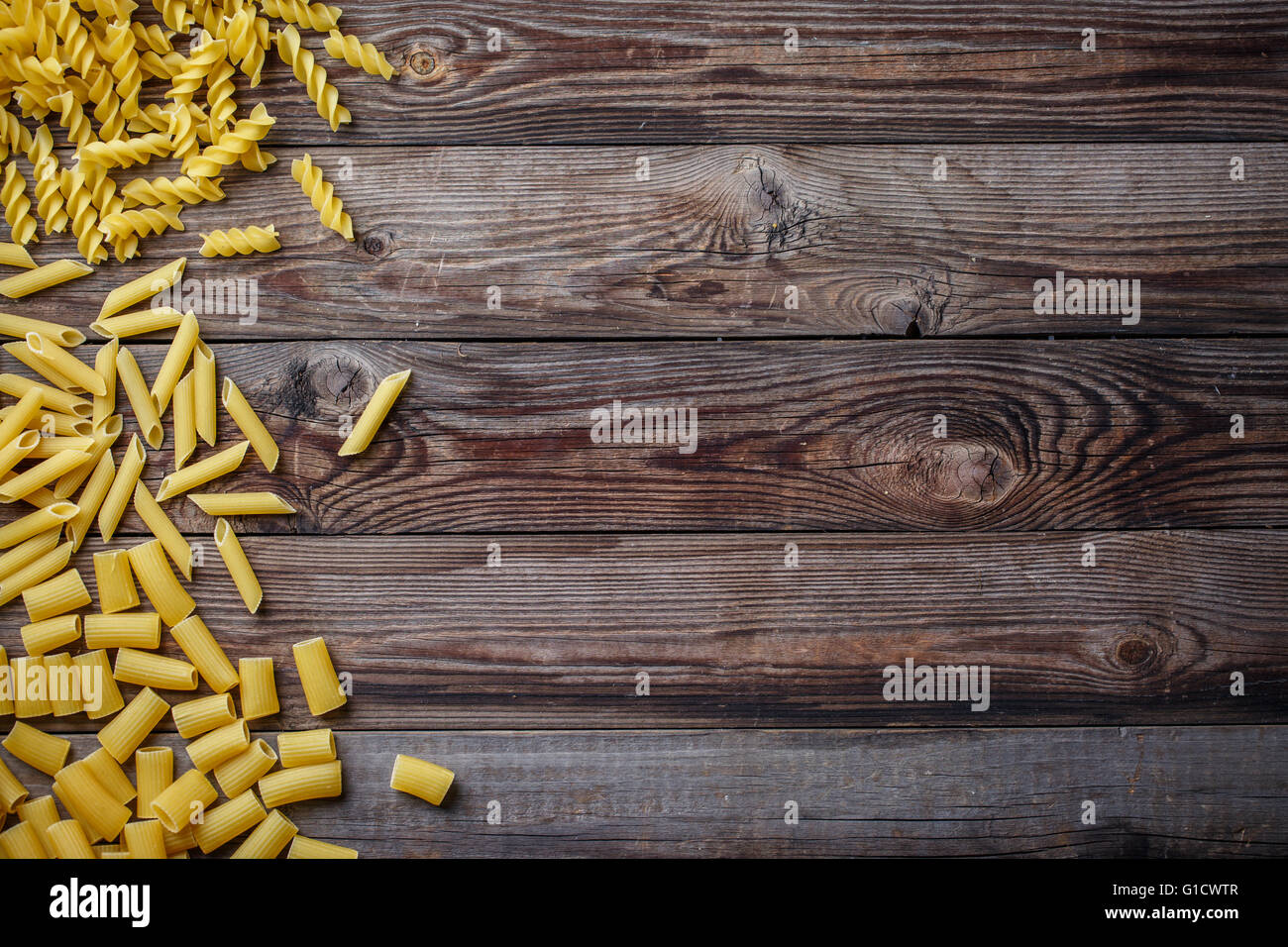 Mixed dried pasta selection on wooden background Stock Photo - Alamy
