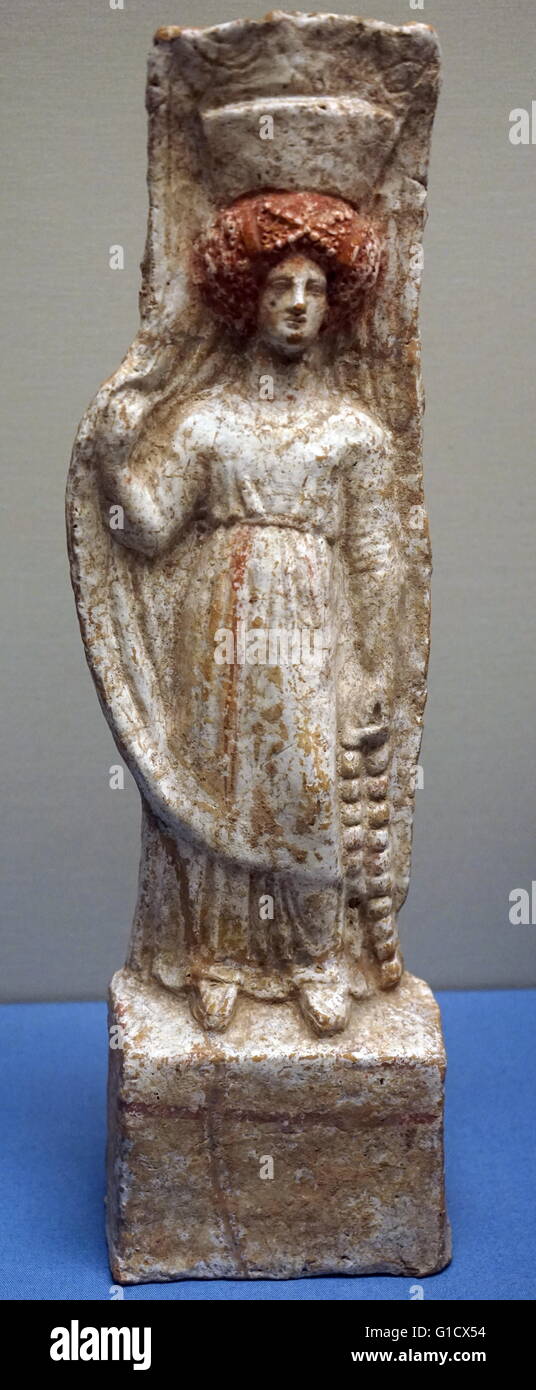 Terracotta figure of a woman wearing a chiton and Polos crown. Dated ...