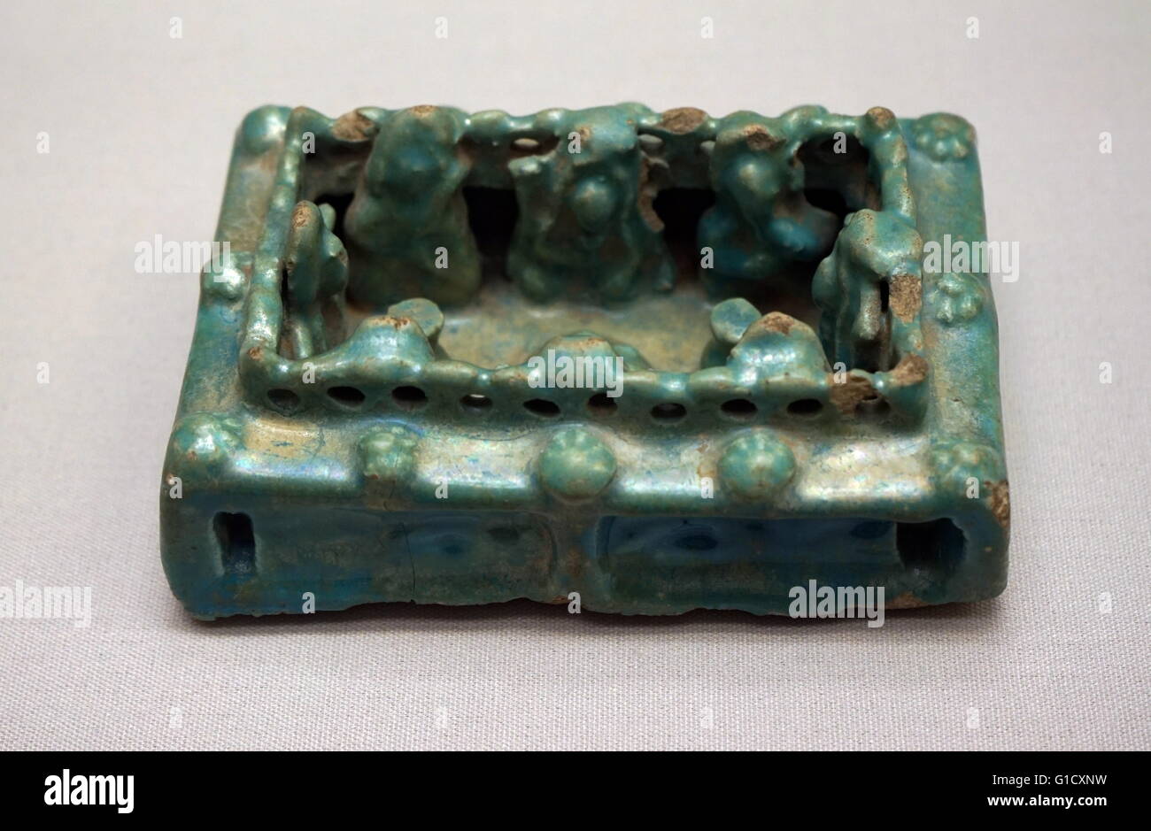 Ceramic model of a house with figures seated in a courtyard. Dated 13th ...