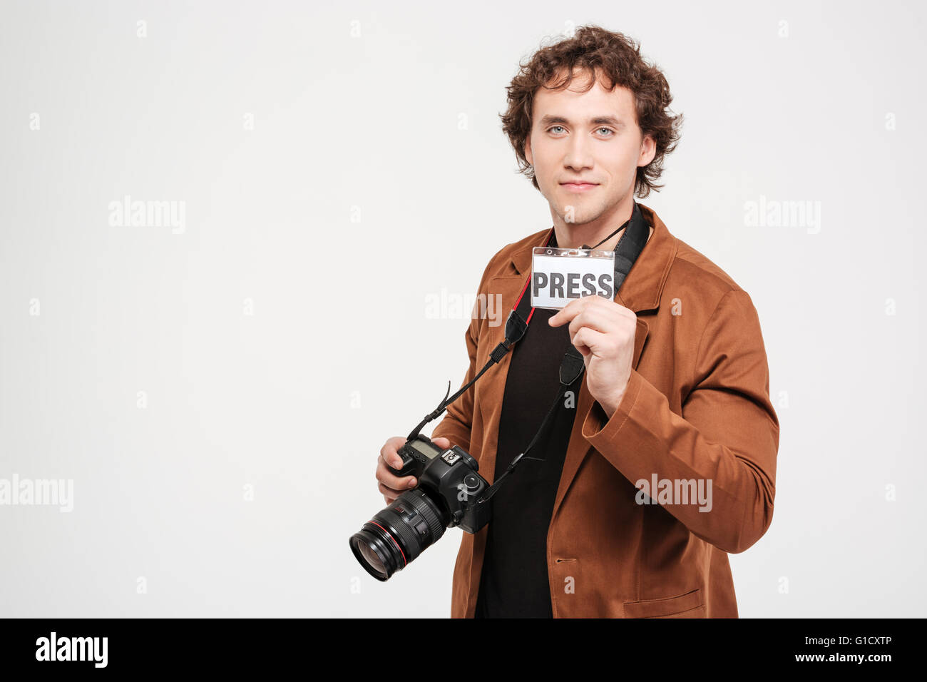 Handsome male reporter holding card with the word press isolated on a ...