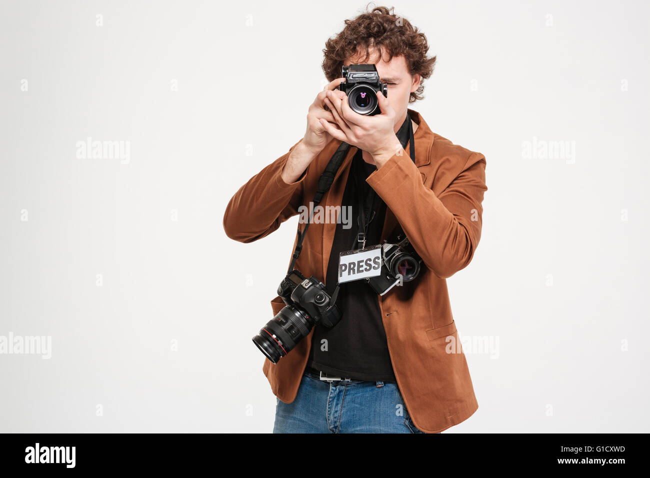 Male reporter making photo on camera isolated on a white background ...