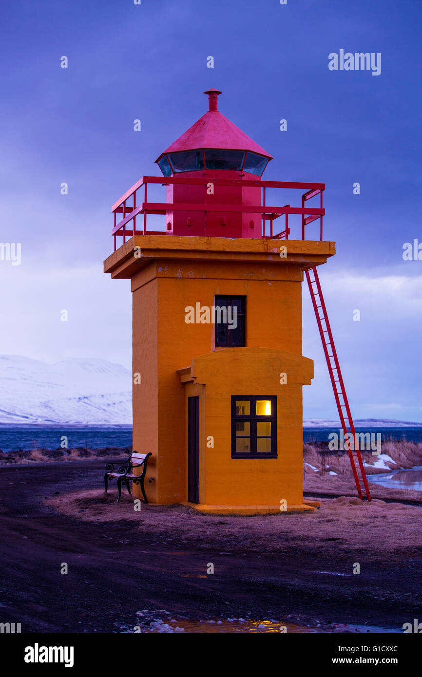 Orange lighthouse at the Ocean in the evening, Iceland Stock Photo - Alamy