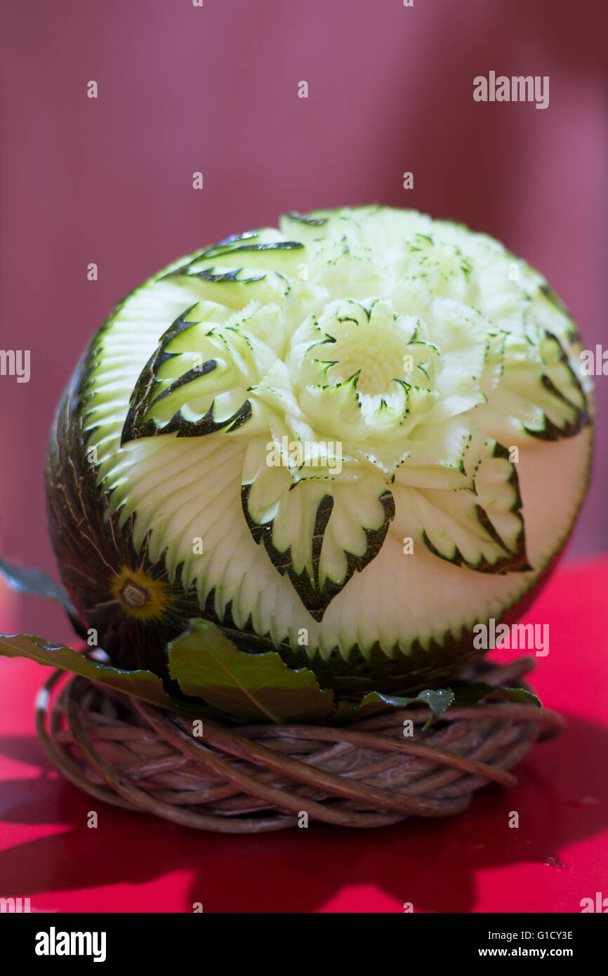 A melon carved with a beautiful flower design Stock Photo - Alamy