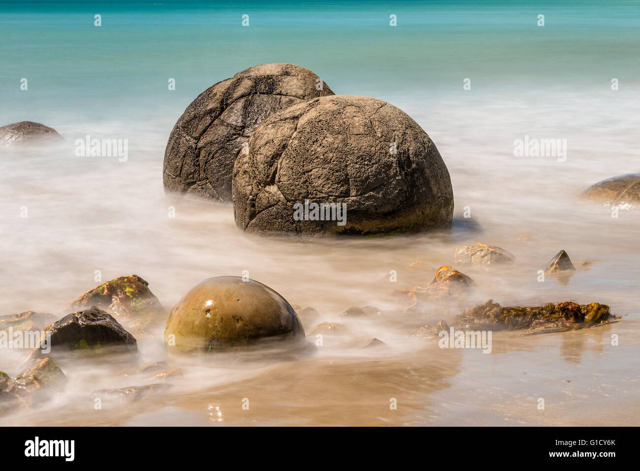 Long exposure image of Moeraki Boulders lying along a stretch of ...