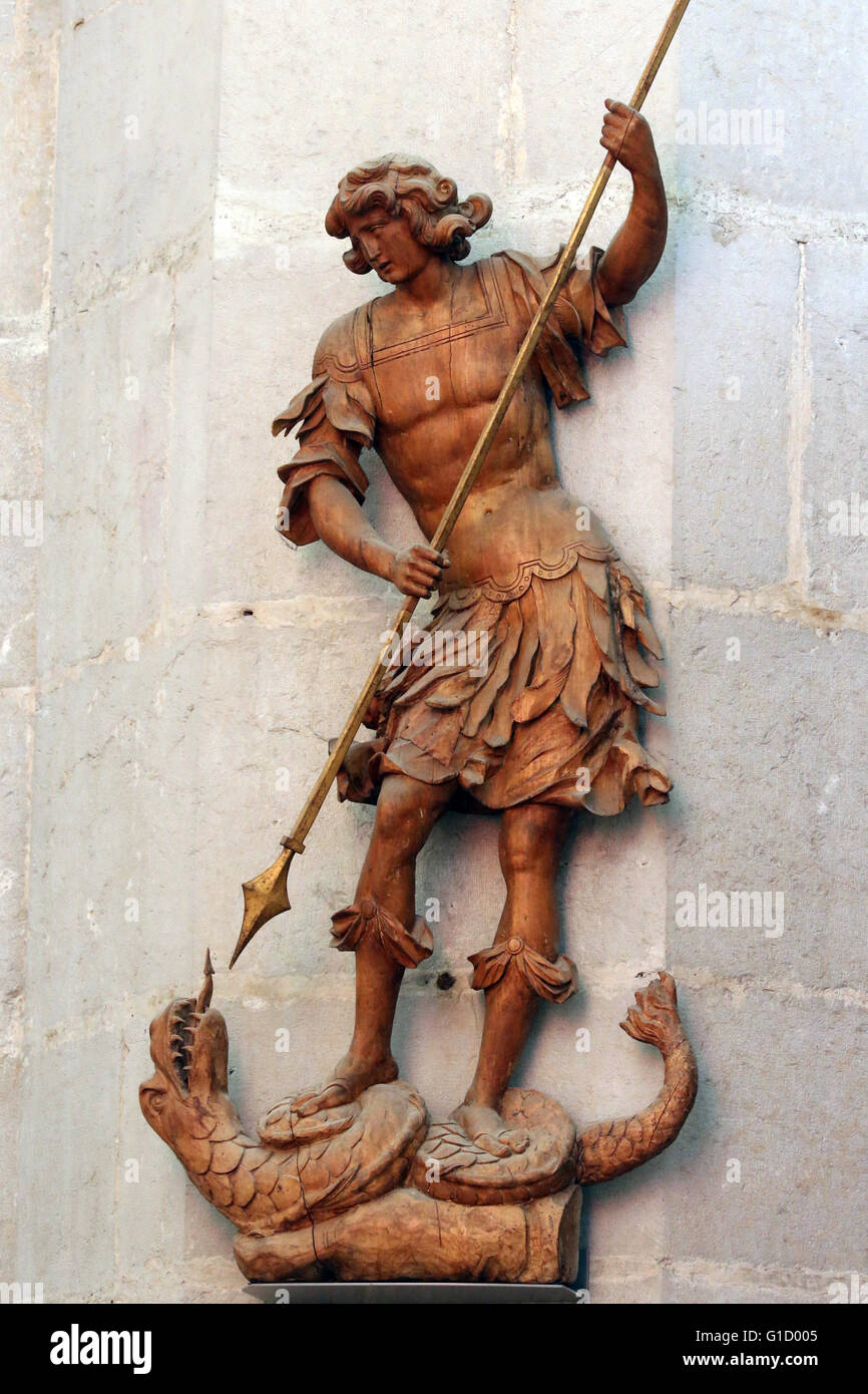 St Michael defeating evil. Saint-Claude Cathedral. Saint-Claude. France ...