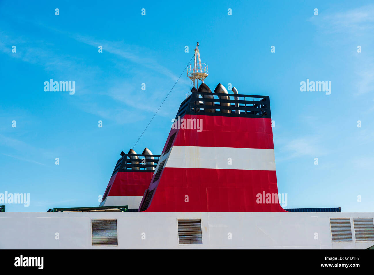 Red chimneys of a cargo ship against clean sky Stock Photo - Alamy