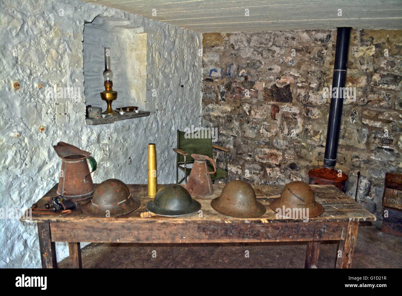Collection of WW1 and WW2 army helmets on a old wooden table, in a ...
