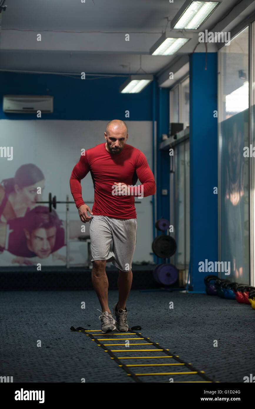 Handsome Man Running On Step Ladders Lying On Floor - Sports And ...