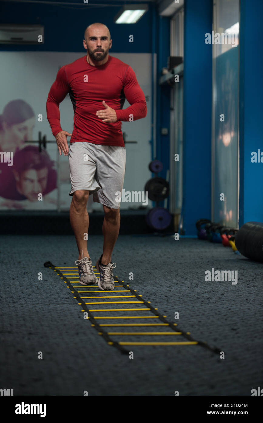 Handsome Man Running On Step Ladders Lying On Floor - Sports And ...