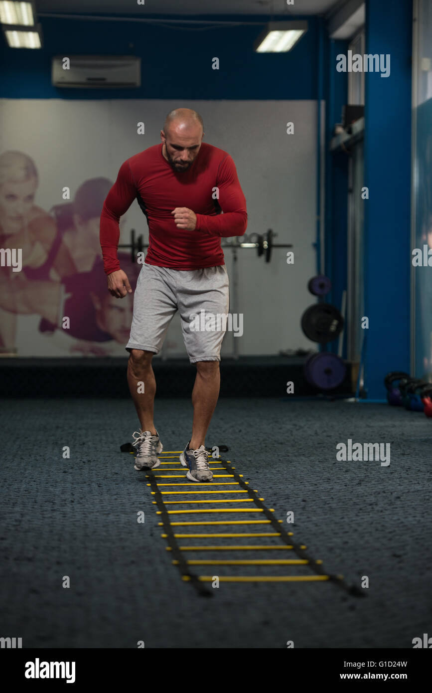 Handsome Man Running On Step Ladders Lying On Floor - Sports And ...