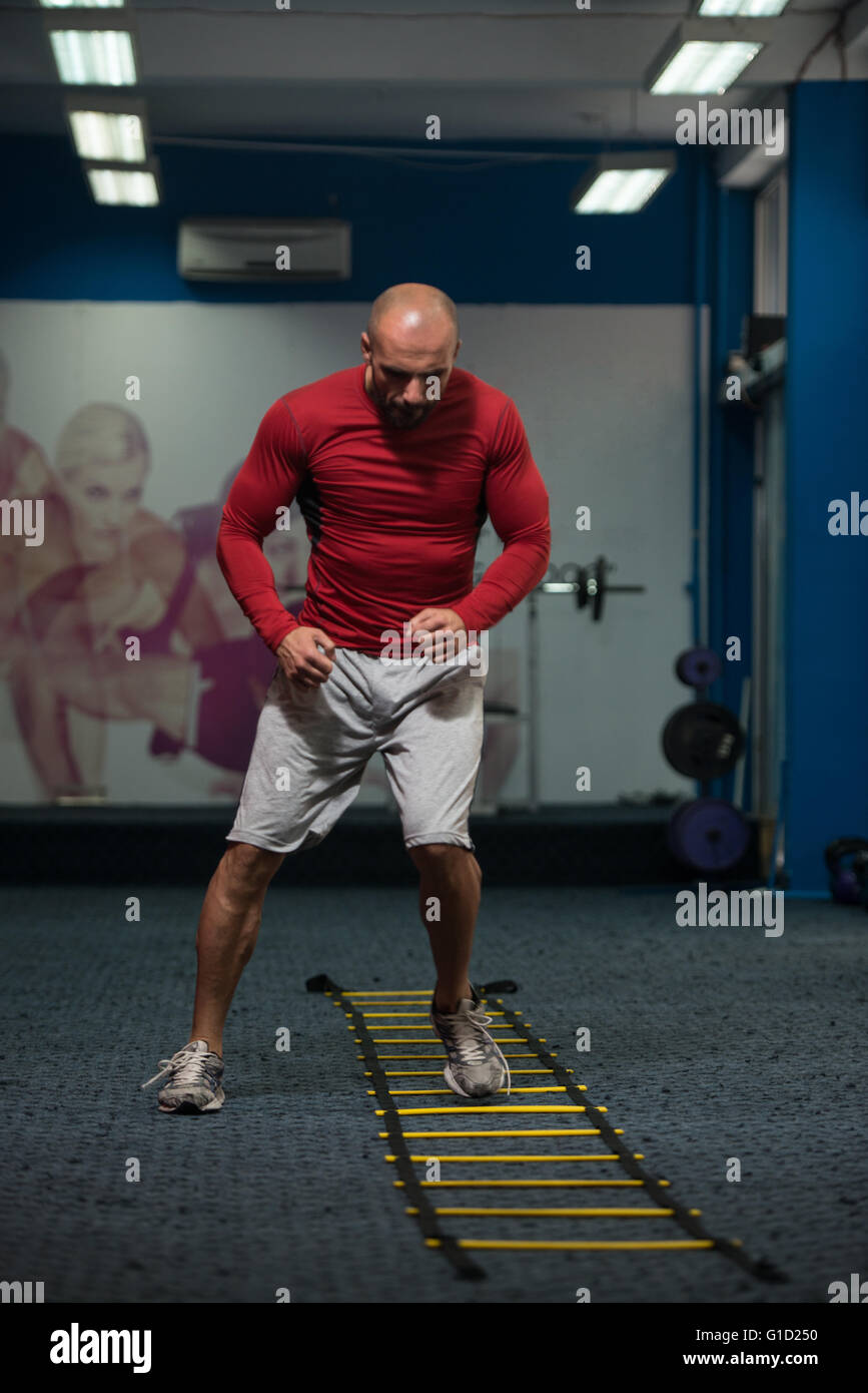 Handsome Man Running On Step Ladders Lying On Floor - Sports And ...