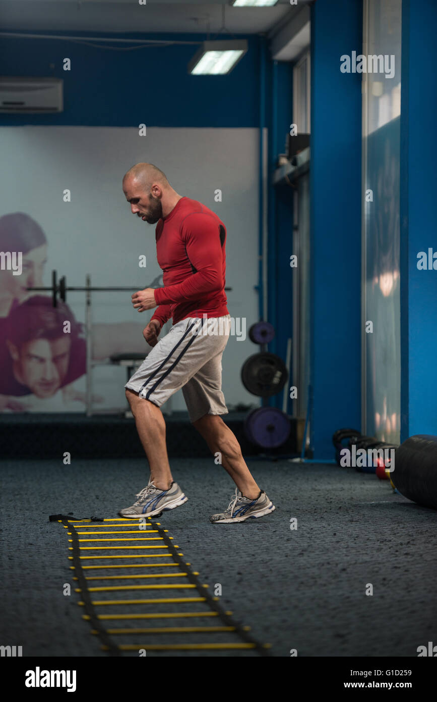 Handsome Man Running On Step Ladders Lying On Floor - Sports And ...