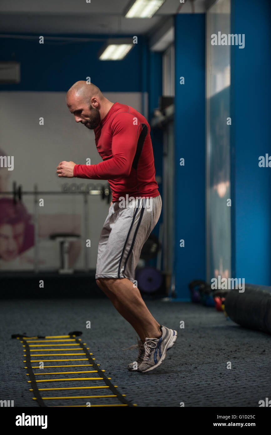 Handsome Man Running On Step Ladders Lying On Floor - Sports And ...
