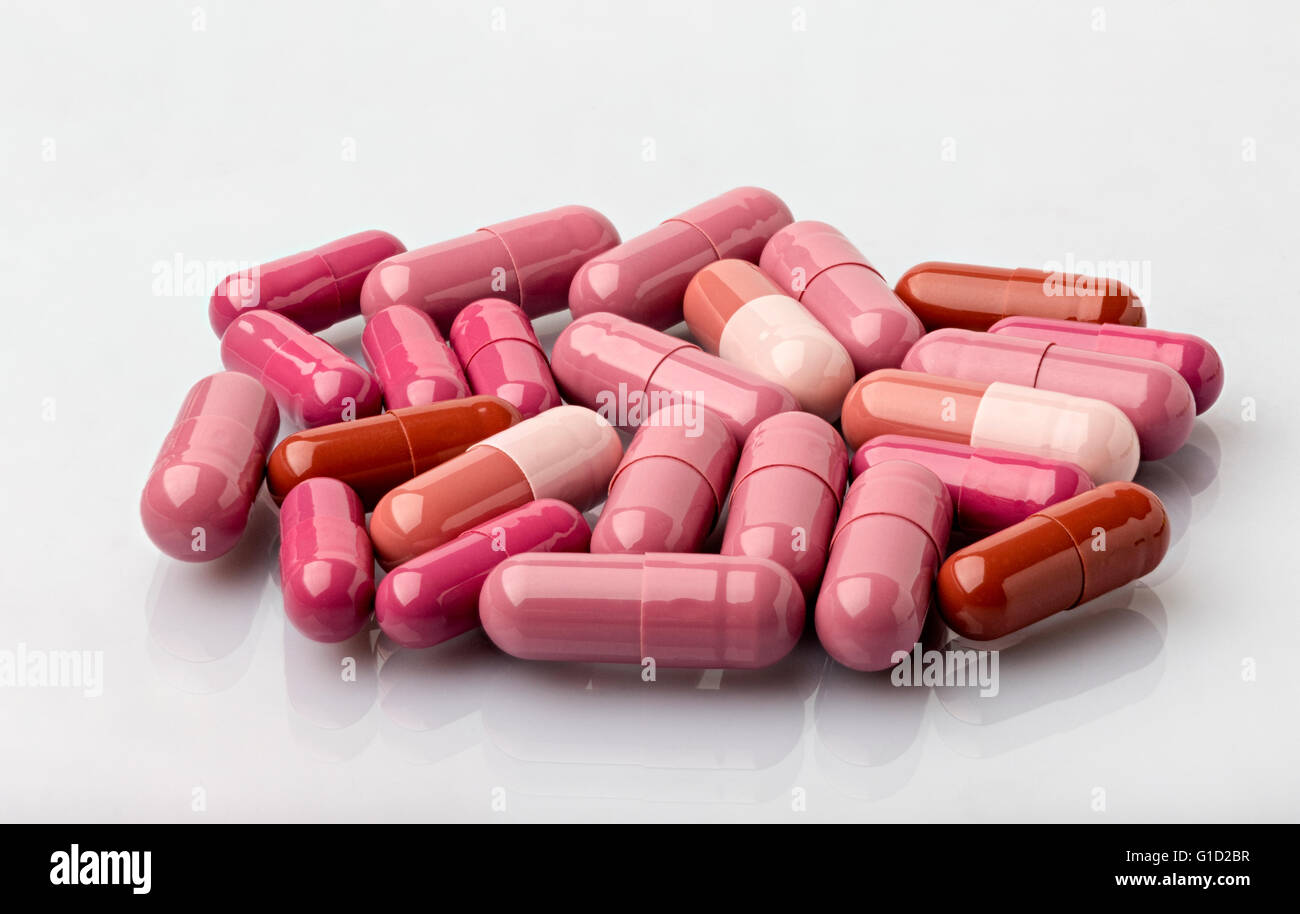 Various medical dosage capsule brown and red Stock Photo - Alamy